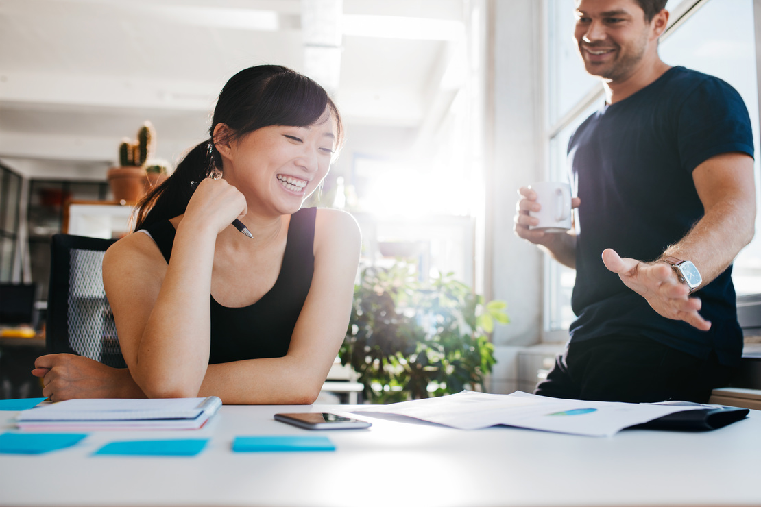 Business partners discussing new ideas and smiling - StartUp Mindset